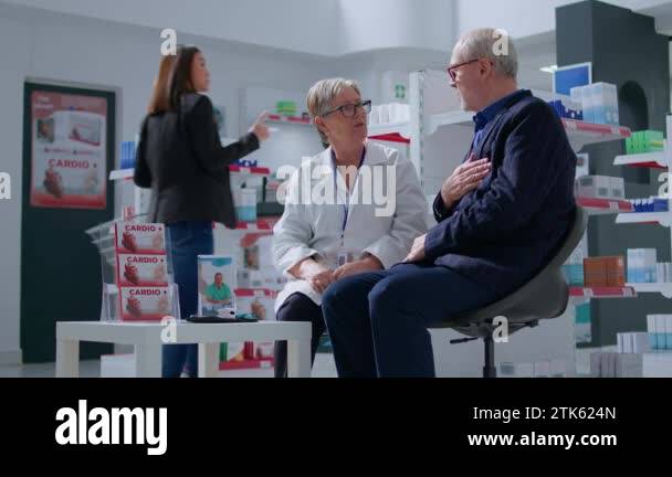 Elderly pharmacist in drugstore with senior patient after finishing ...