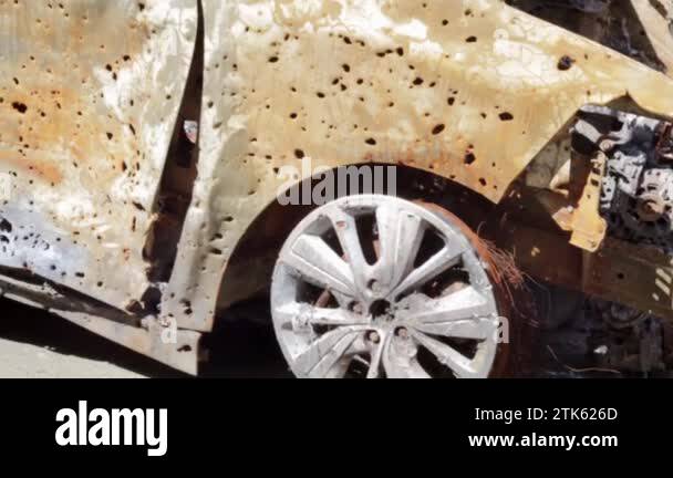 Burnt car body, riddled with bullets. War of Russia against Ukraine ...