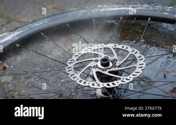 Washing bike with jet of water. Bike mechanic cleaning bicycle wheel ...
