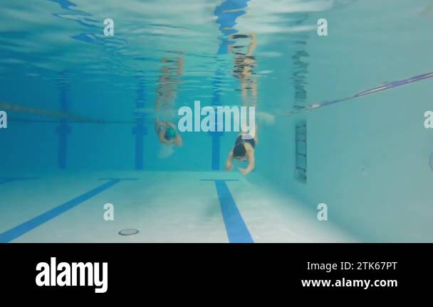 Woman athlete swims underwater in the pool. Slow motion of a female ...