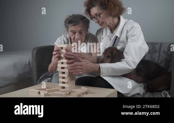 Seniors female patient solve puzzle. Old female with cognitive disorder ...
