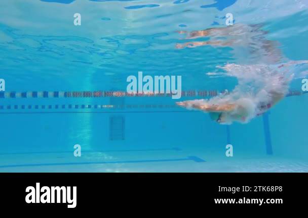 Woman athlete swims underwater in the pool. Slow motion of a female ...