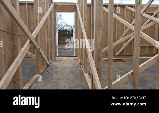 Wood frame building under construction in suburban new stick beams ...