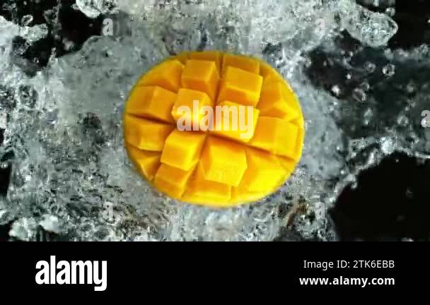 Super slow motion of mango with water splash. Filmed on high speed ...