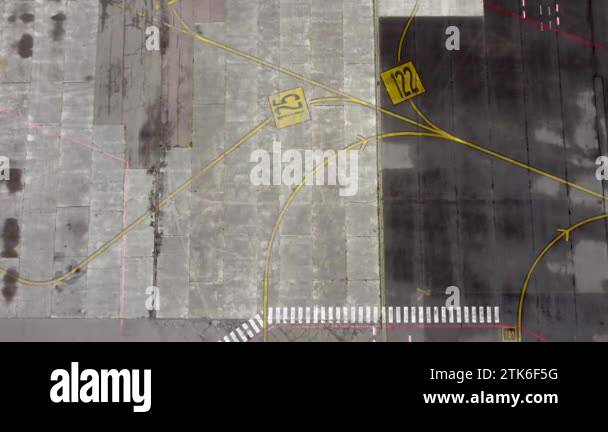 Directional sign markings on the tarmac of runway at commercial airport ...