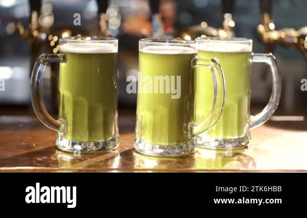 Three pints of beer standing on the bar counter in a modern restaurant ...
