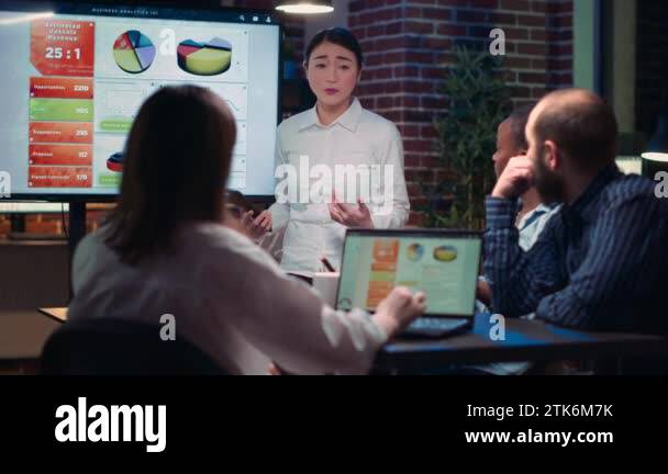 Asian businesswomen giving analytics research presentation in business ...