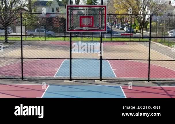 This video shows views of an empty basketball court with rims removed ...