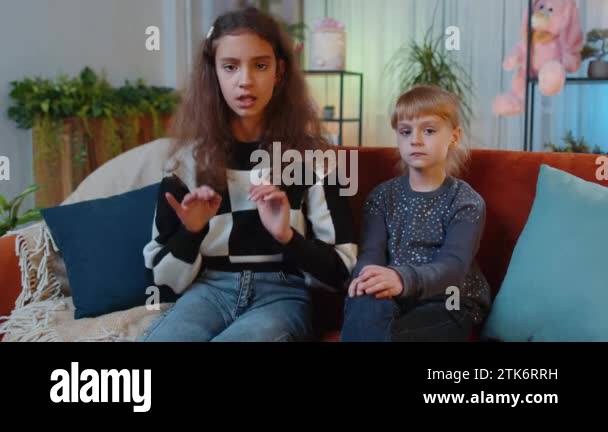 Child and little sister kid girls say no hold palm folded crossed hands ...