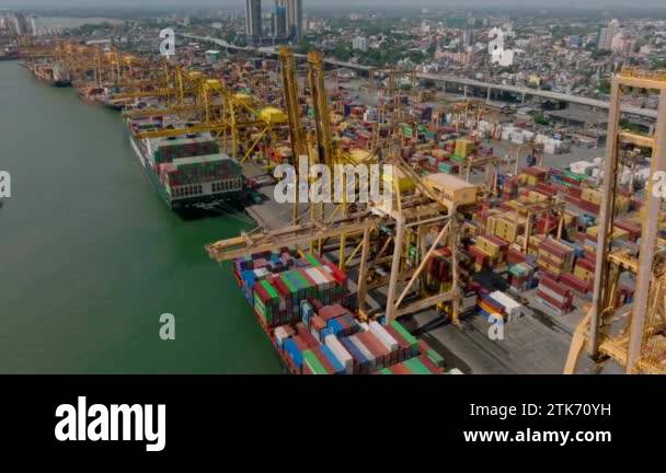 Huge cranes loading large cargo ships. Fly over container terminal in ...