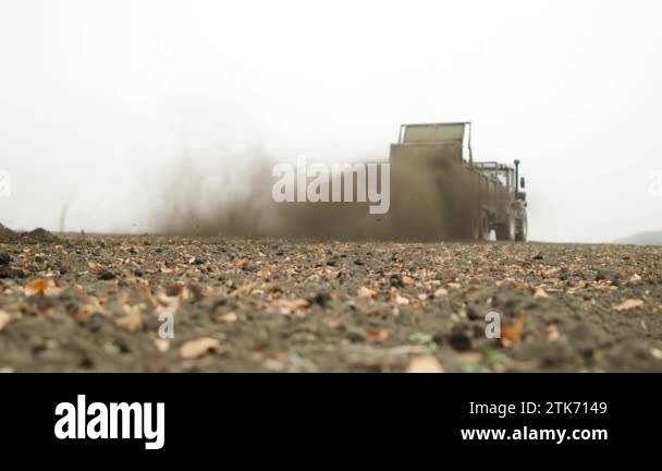 Fertilizing fields with compost. Fertilization of earth with organic ...