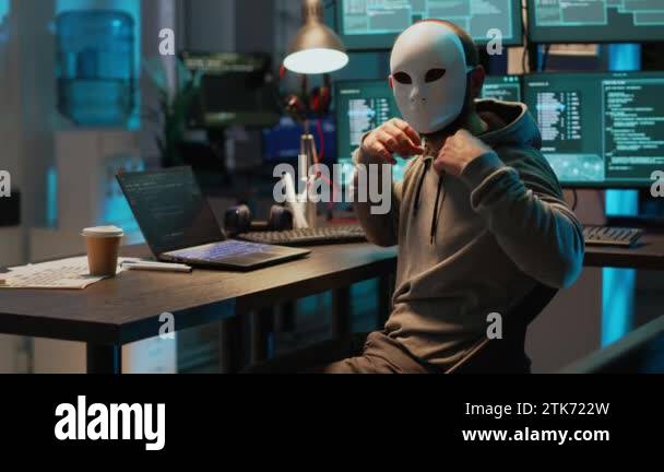 Masked Scammer Hacking Computer Network Late At Night Working On