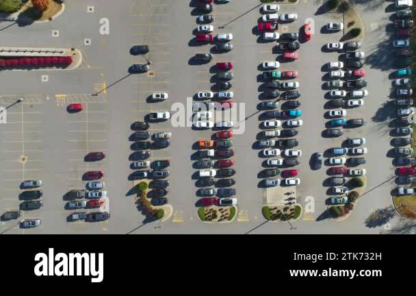 Aerial view of large parking lot with many parked colorful cars ...