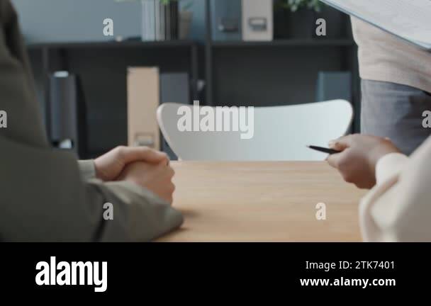 Midsection shot of Caucasian Man coming to job interview with Caucasian ...