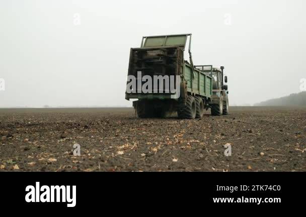 Fertilizing fields with compost. Fertilization of earth with organic ...
