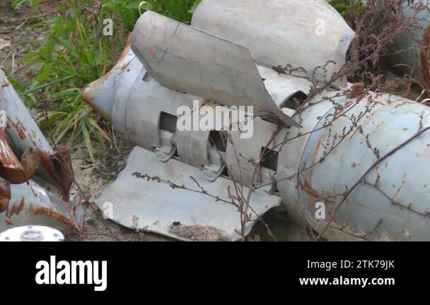 A shell from a multiple rocket launcher system on the grass. The shell ...