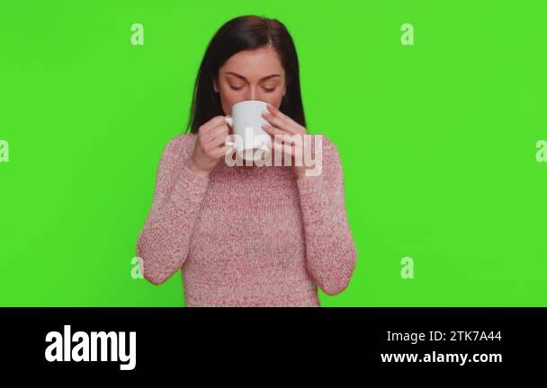 Pretty young woman smelling drinking cup of beverage hot coffee, taking ...