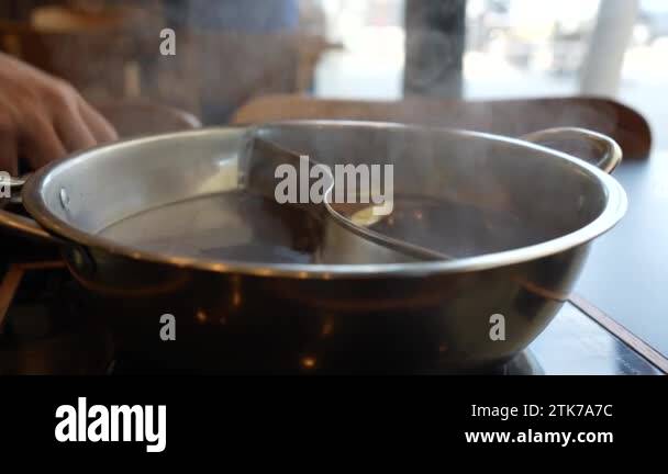 A half pot and half soup boiling in Sukiyaki pot, ready for eat. Shabu ...