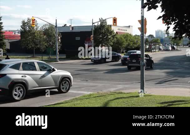 road with two parking lot exit entrances with lights, lights changing ...