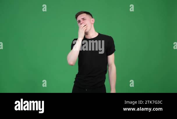 Tired Caucasian man is caught in a yawn. His mouth opens wide ...