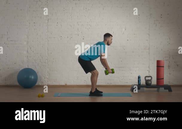 Side view. Athletic male fitness coach doing exercises at the home ...