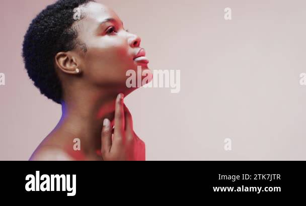 African american woman with short dark hair in blue and pink light with ...