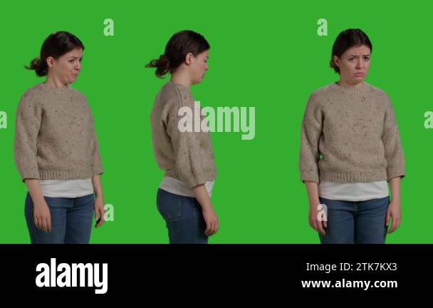 Discontent mad girl acting upset and displeased, posing over green ...