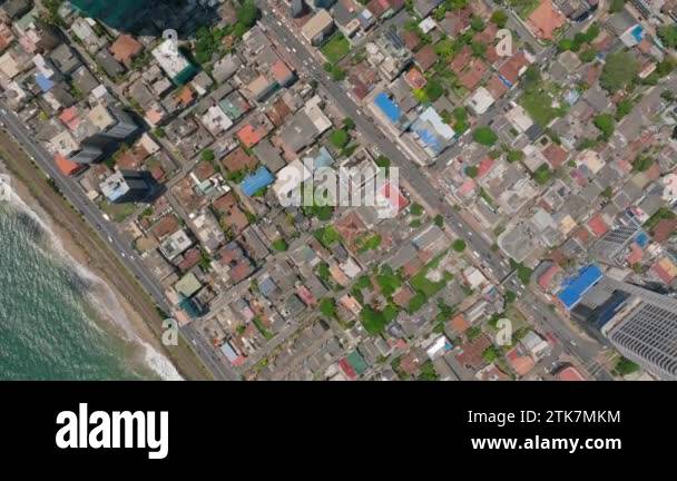 Top down panning footage of urban borough at sea side. Busy roads and ...