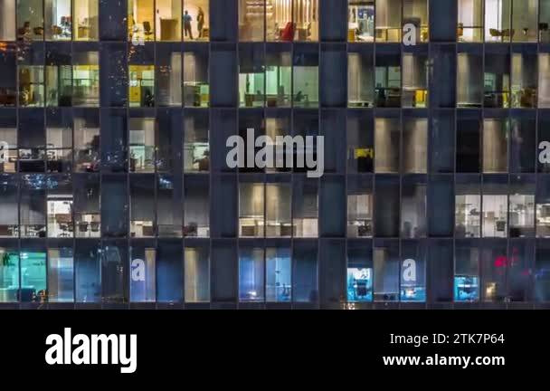 Night aerial view of office building glass window facade with ...