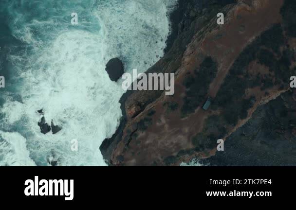 Epic and majestic aerial top down view on small 4x4 camper van drive on ...