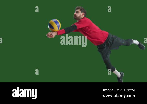 Young man bouncing, falling and batting ball. Athlete playing ...