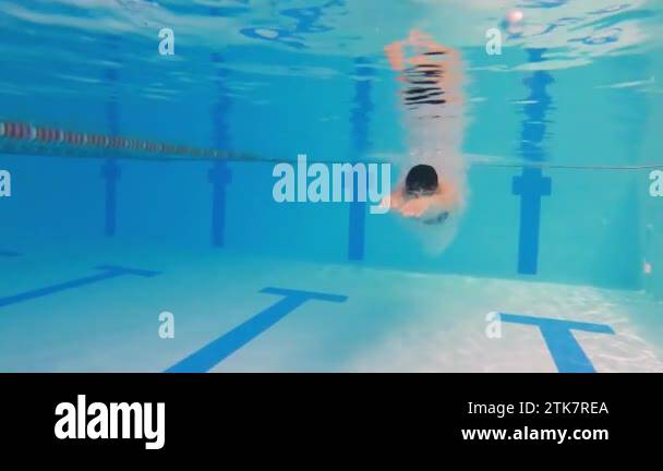 Woman athlete swims underwater in the pool. Slow motion of a female ...