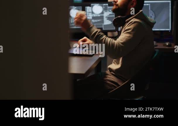 Young Male Developer Typing Server Code On Multiple Screens Using Coding Language On Laptop Late