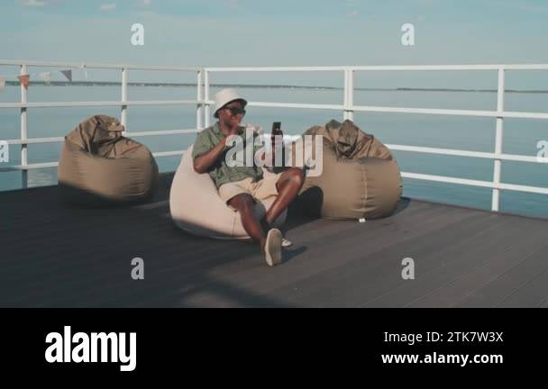 Man sitting on bean Stock Videos & Footage - HD and 4K Video Clips - Alamy