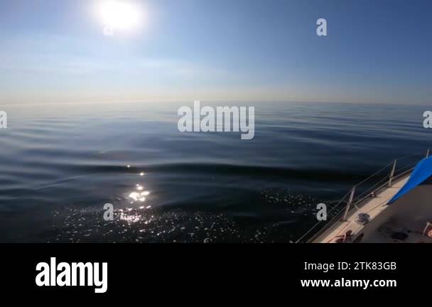Calm nature background of open sea water with light waves in slow ...