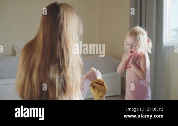 Mom shows daughter package, yellow dress. Little girl experiences ...