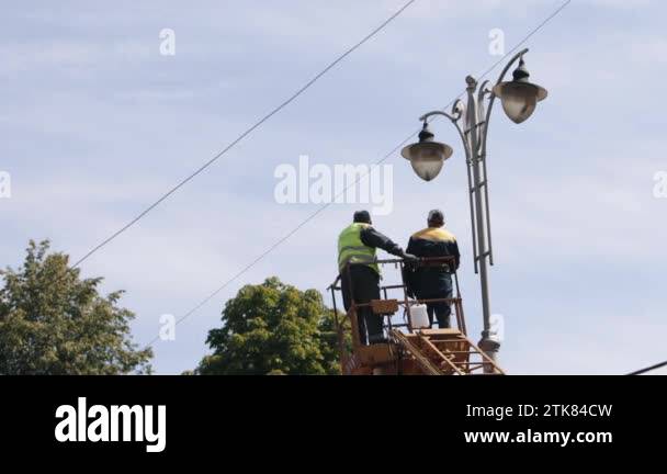 Electric technical, street lamp, during installation. Workmen working ...