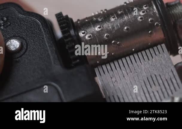 Retro music box mechanism with spinning cylinder and cogs in macro. Old ...