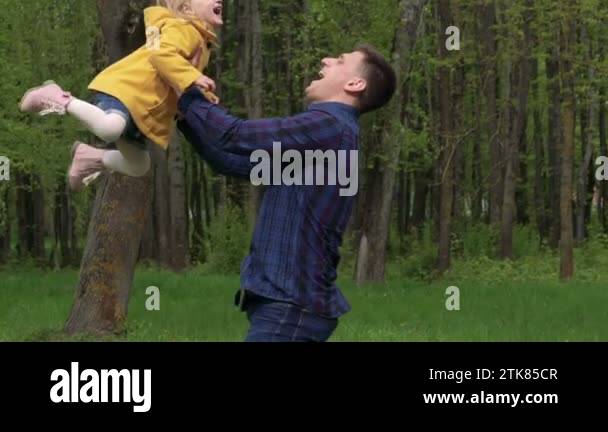 Little three years old girl running to father, turning around. Slowly ...