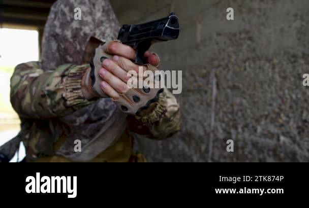 Mercenary soldier shooting from his handgun during special operation ...