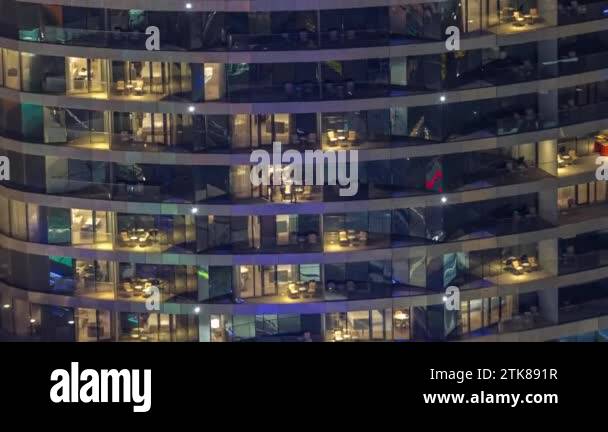 Outside view of windows in apartments of a high class building at night ...