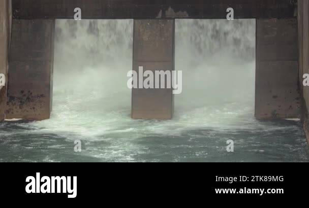 Hydroelectric powerplant with water splashing under the dam spillway on ...
