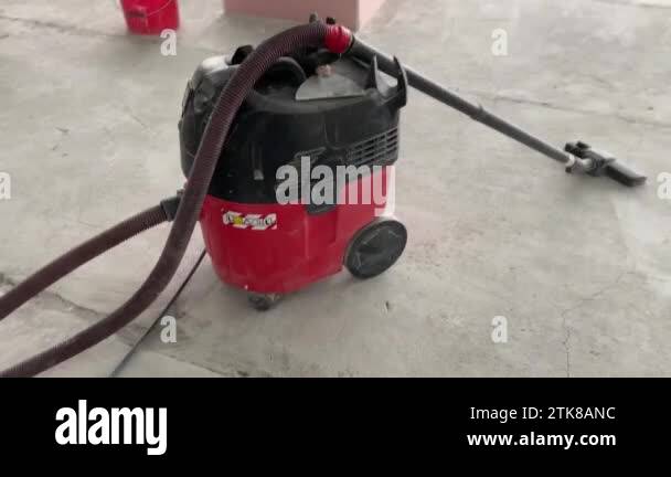 Construction works. The builder removes dust and small debris from the ...