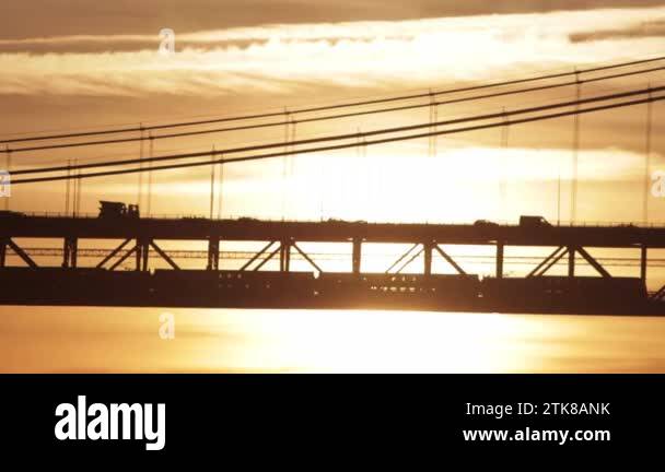A train riding on the secod level of the suspension two-storey bridge ...