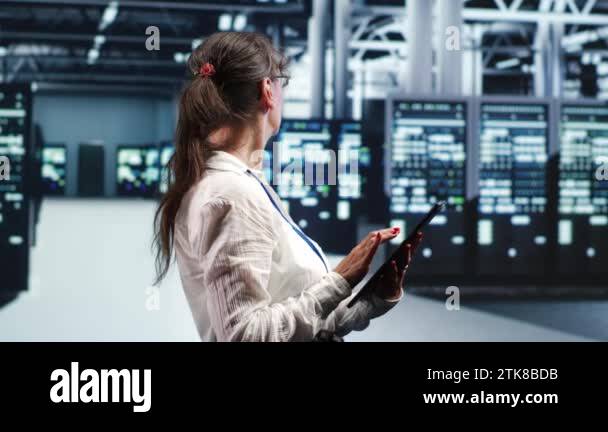 Old engineer working in data center housing GPU dedicated servers that can process artificial ...