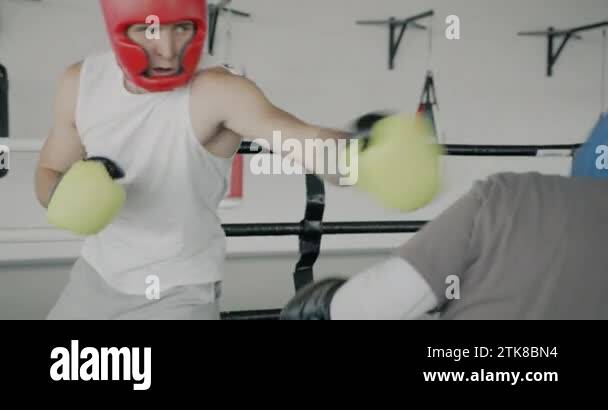 Slow motion of young athlets boxers fighting in boxing ring throwing ...