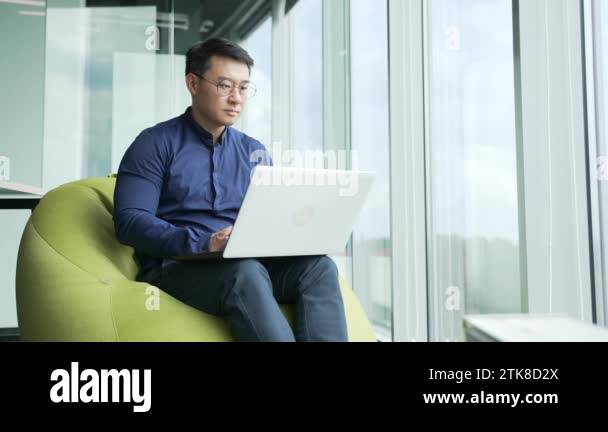 Busy middle aged IT specialist programmer with glasses working typing ...