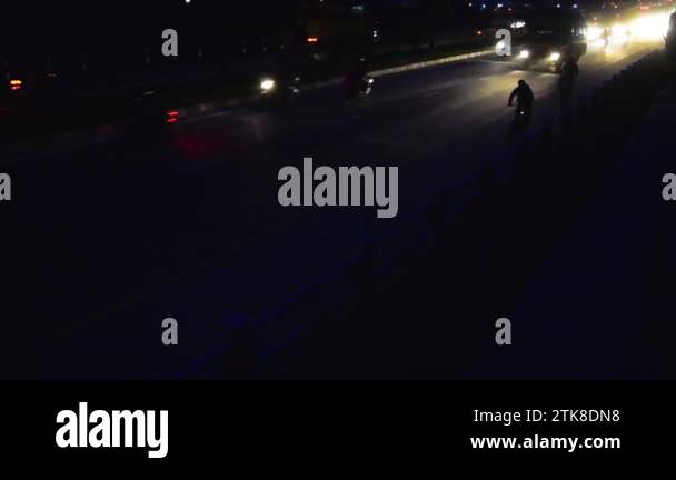 2 people riding bicycle alongside a Huge traffic full of vehicles in a ...