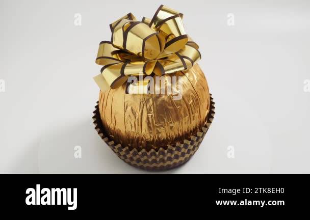 Rotating Chocolate balls wrapped in golden paper. Chocolate bar with ...
