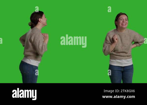 Close up of young adult greeting person with wave, smiling in studio ...
